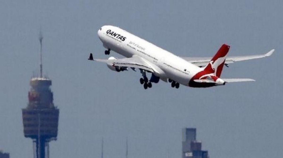 Passengers evacuate Qantas plane via emergency slides at Sydney airport