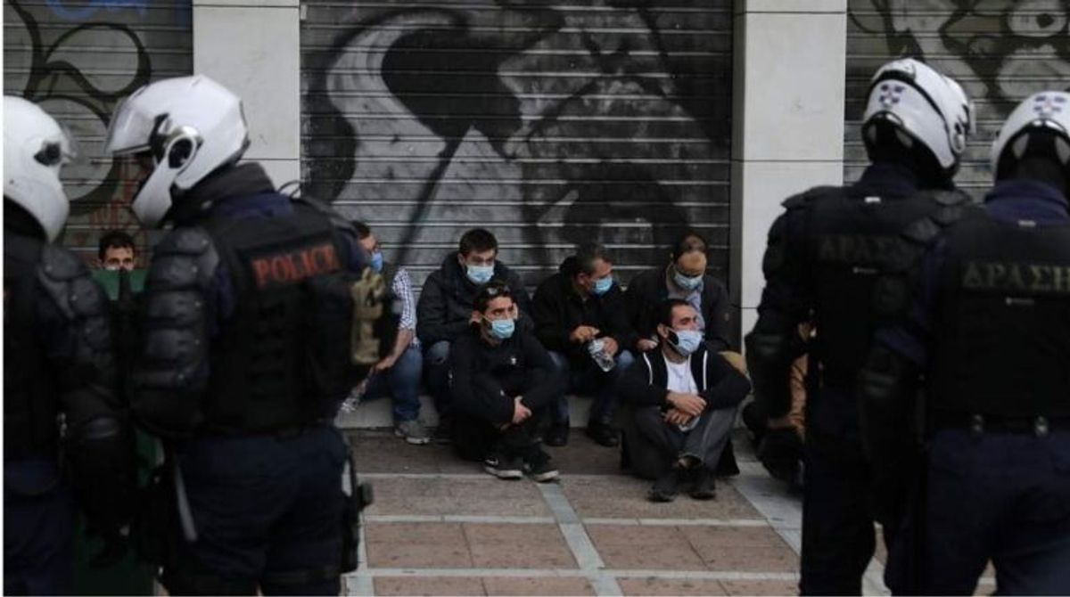 Greek police arrest dozens at march in memory of slain teen