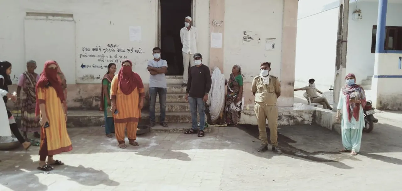 Anganwadi workers distributing take home ration kits to beneficiaries
